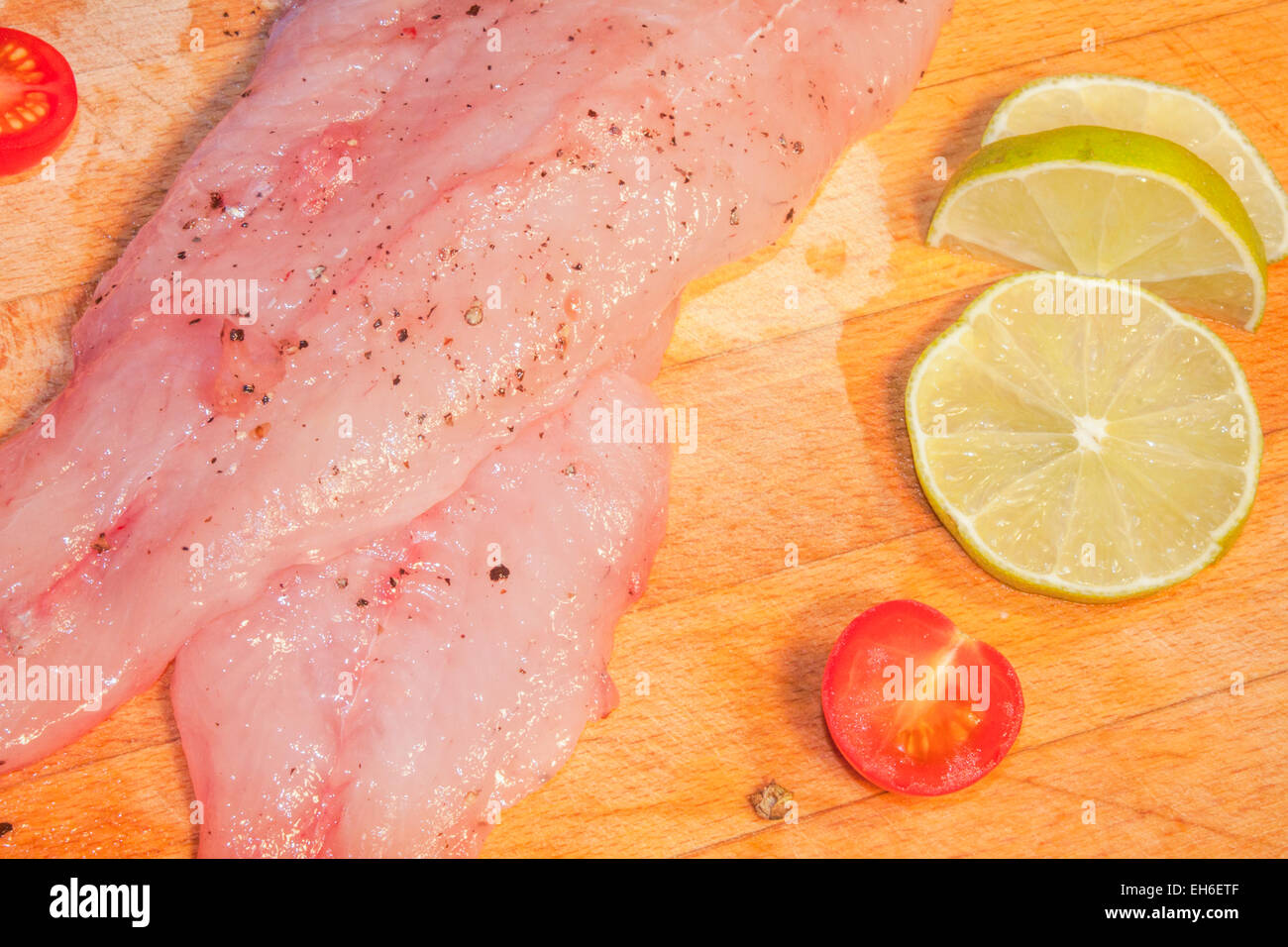 Light zander fillets, near lime and cherry tomatoes Stock Photo - Alamy
