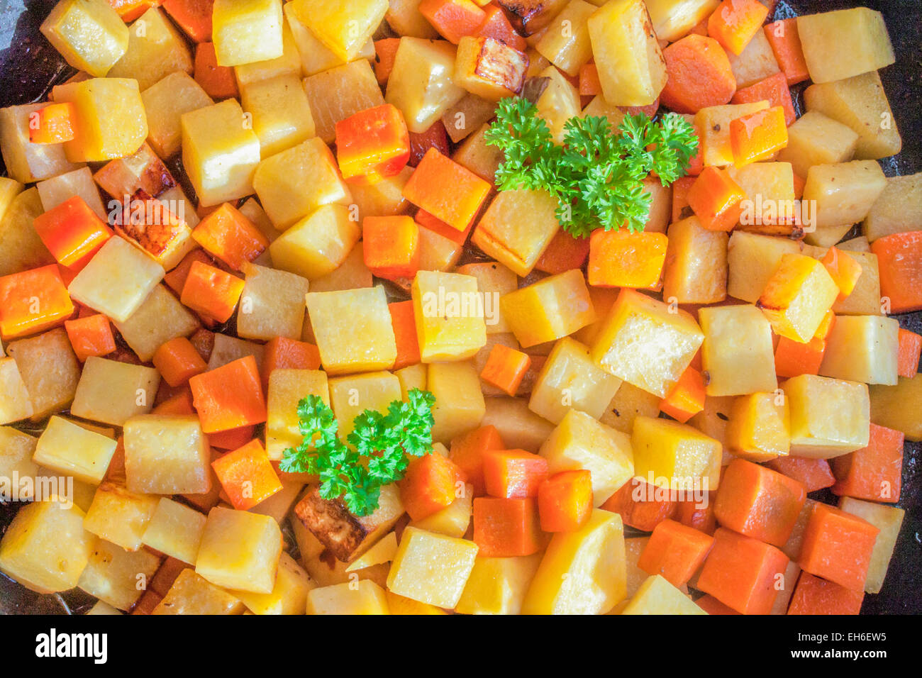 Closeup on orange carrot and yellow swede dice and green parsley Stock ...