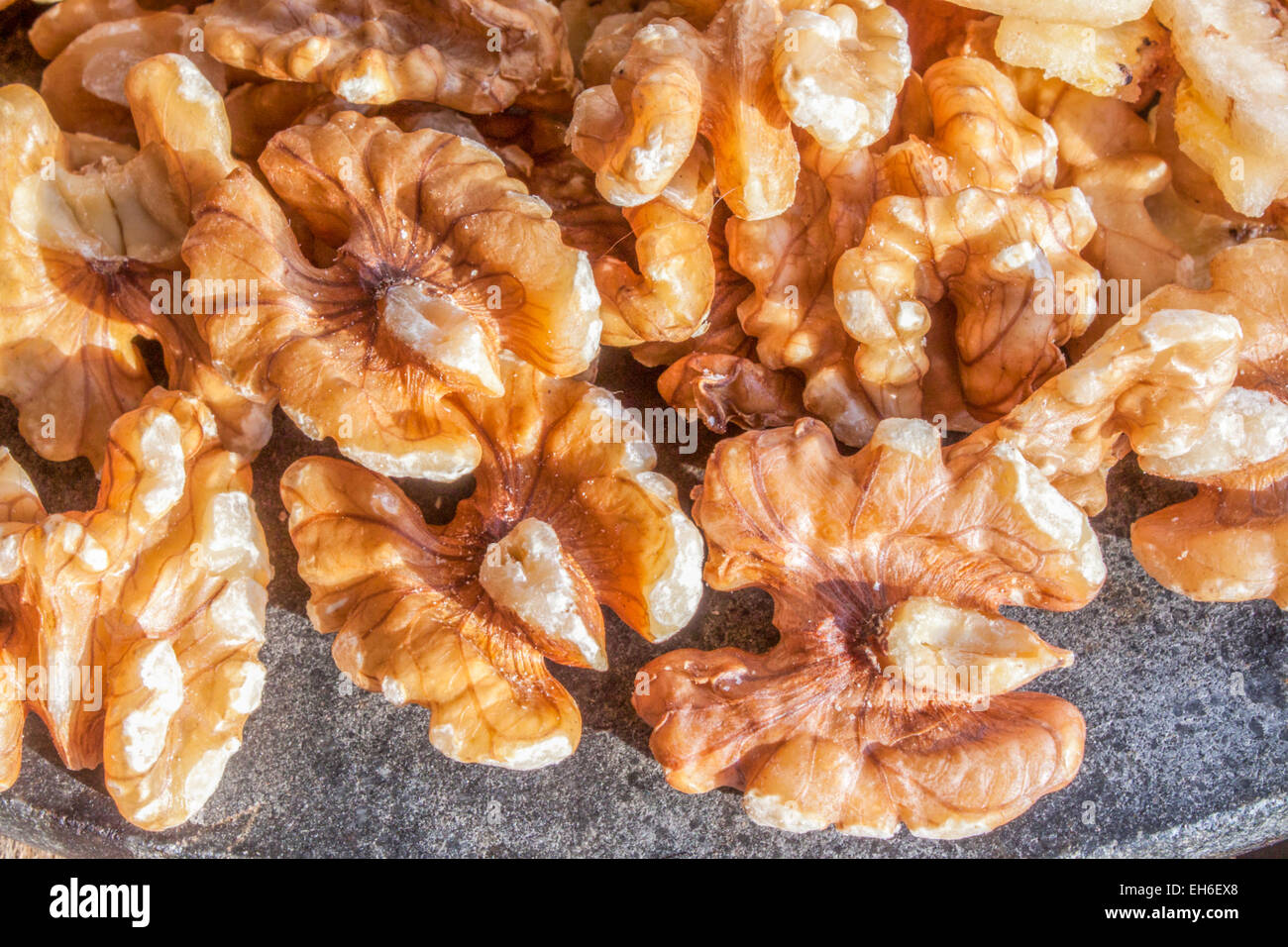 A lot of walnuts, on a stone plate Stock Photo - Alamy
