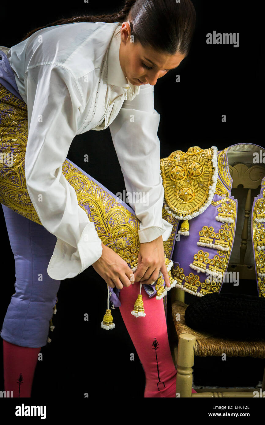 Woman bullfighter by dressing with vest on your back on a black ...