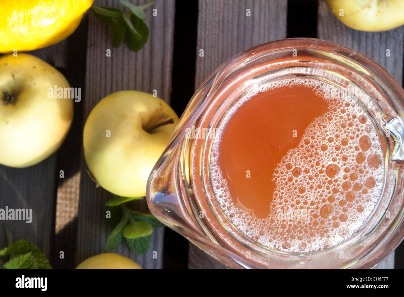 A can full of apple juice, near apples, mint, lemon and lime Stock ...