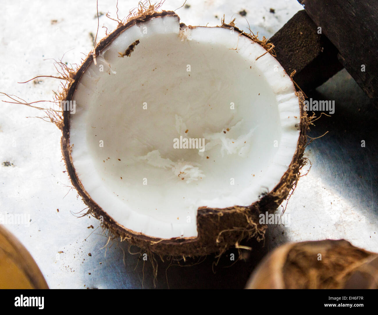 Brown coconut half, on a steele table Stock Photo - Alamy