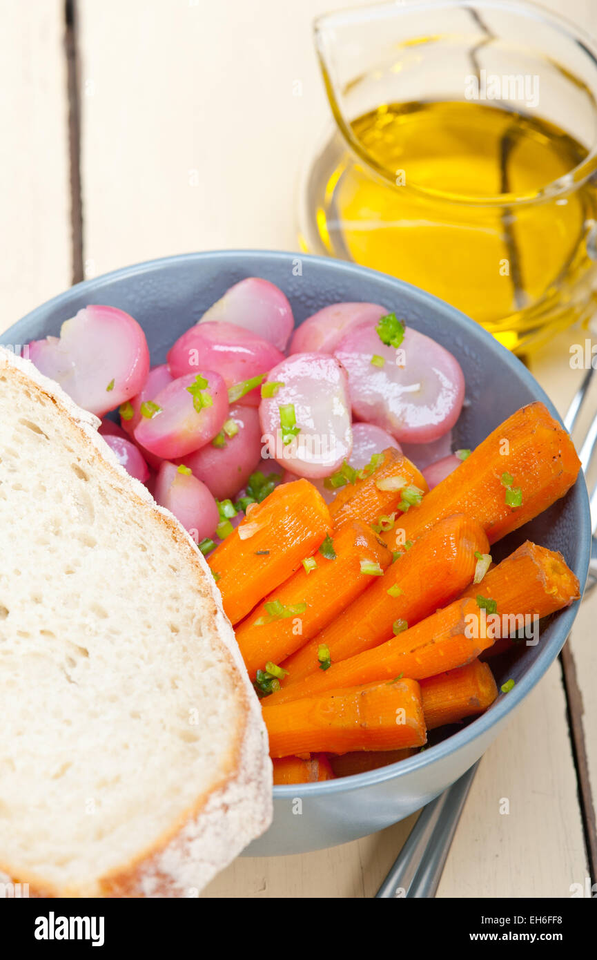 bowl of steamed root vegetable on a rustic white wood table Stock Photo ...