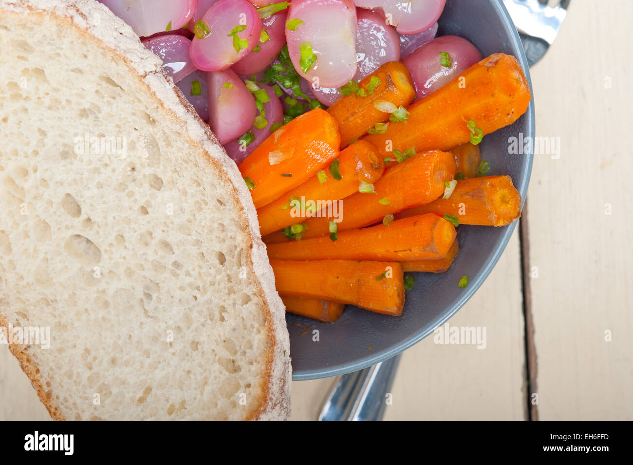 bowl of steamed root vegetable on a rustic white wood table Stock Photo ...