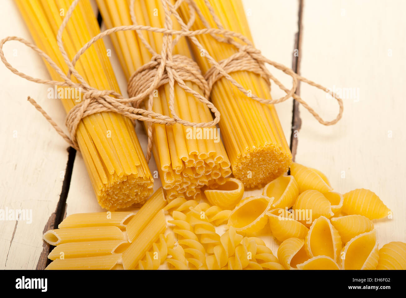 bunch of Italian pasta type on a white rustic table Stock Photo - Alamy