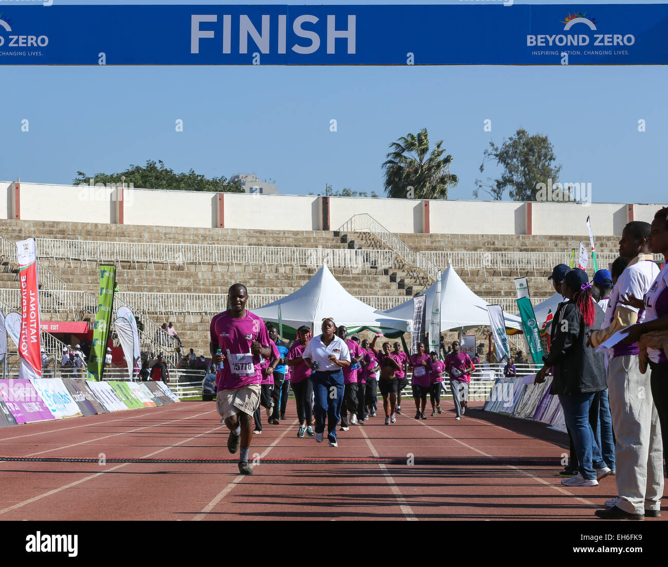 Nairobi, Kenya. 8th Mar, 2015. Athletes arrive at the finish point ...