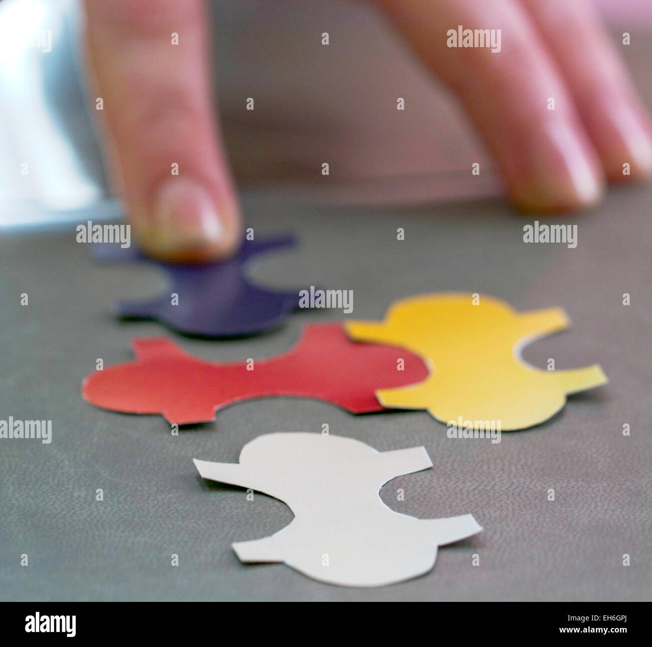 Fitting the last piece of puzzle in place Stock Photo - Alamy