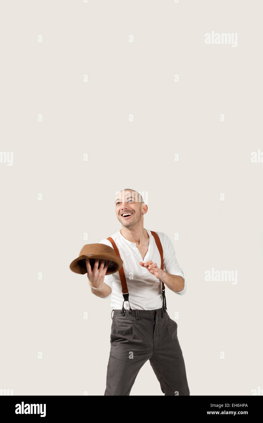 man throws his hat in air, portrait in studio Stock Photo - Alamy