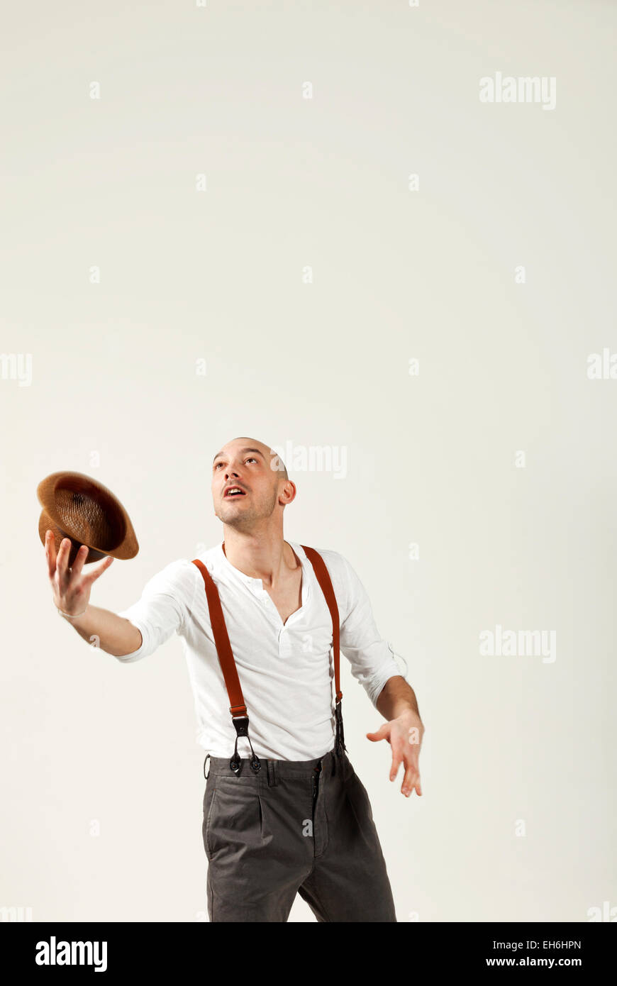 man throws his hat in air, portrait in studio Stock Photo - Alamy