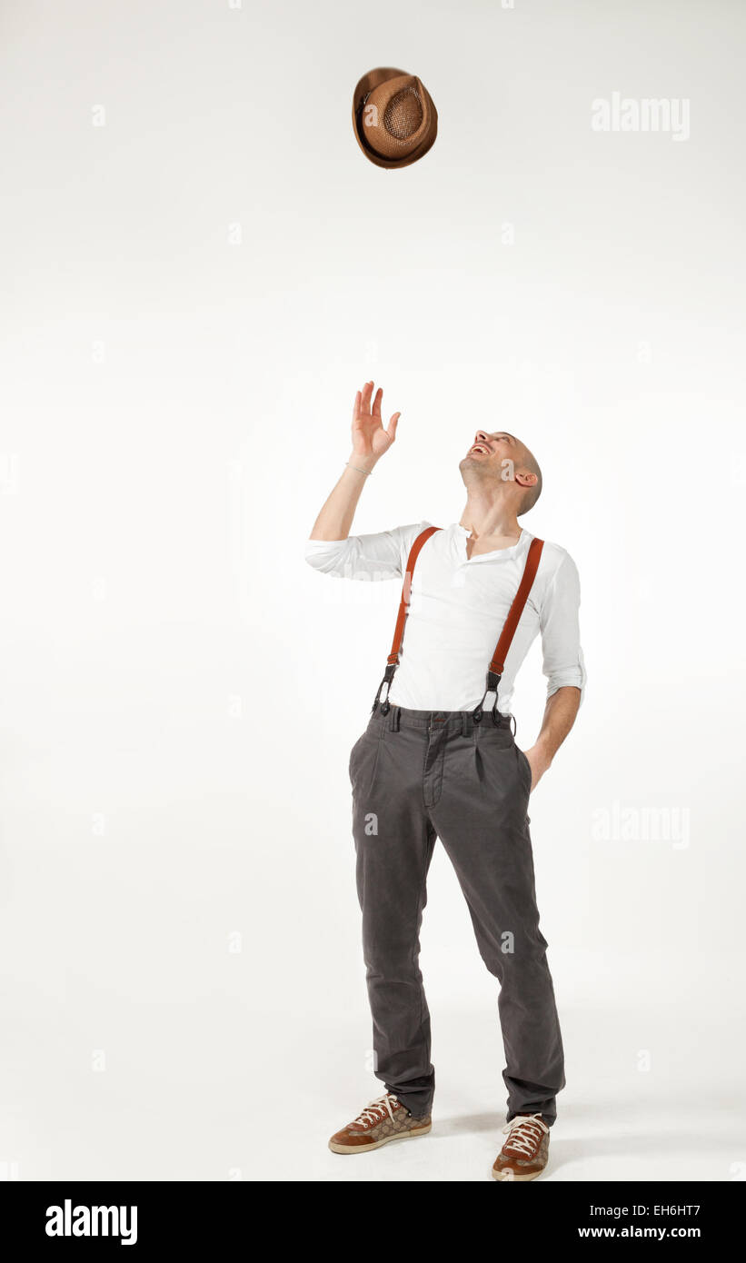 man throws his hat in air, portrait in studio Stock Photo - Alamy