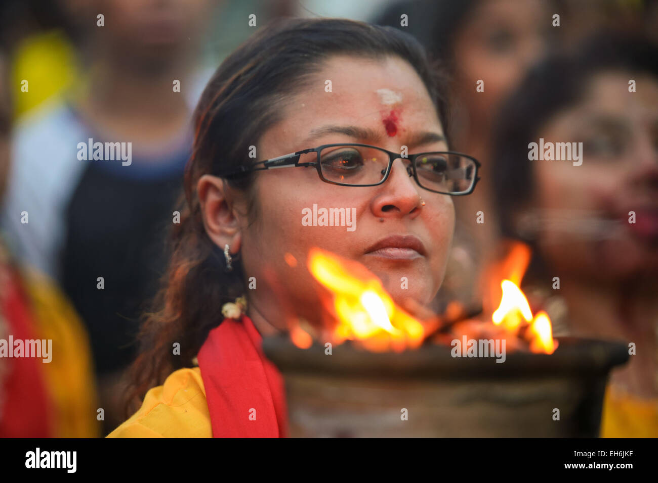 Woman hindu pilgrim with fire kavaldi walking to Batu Cave temple ...