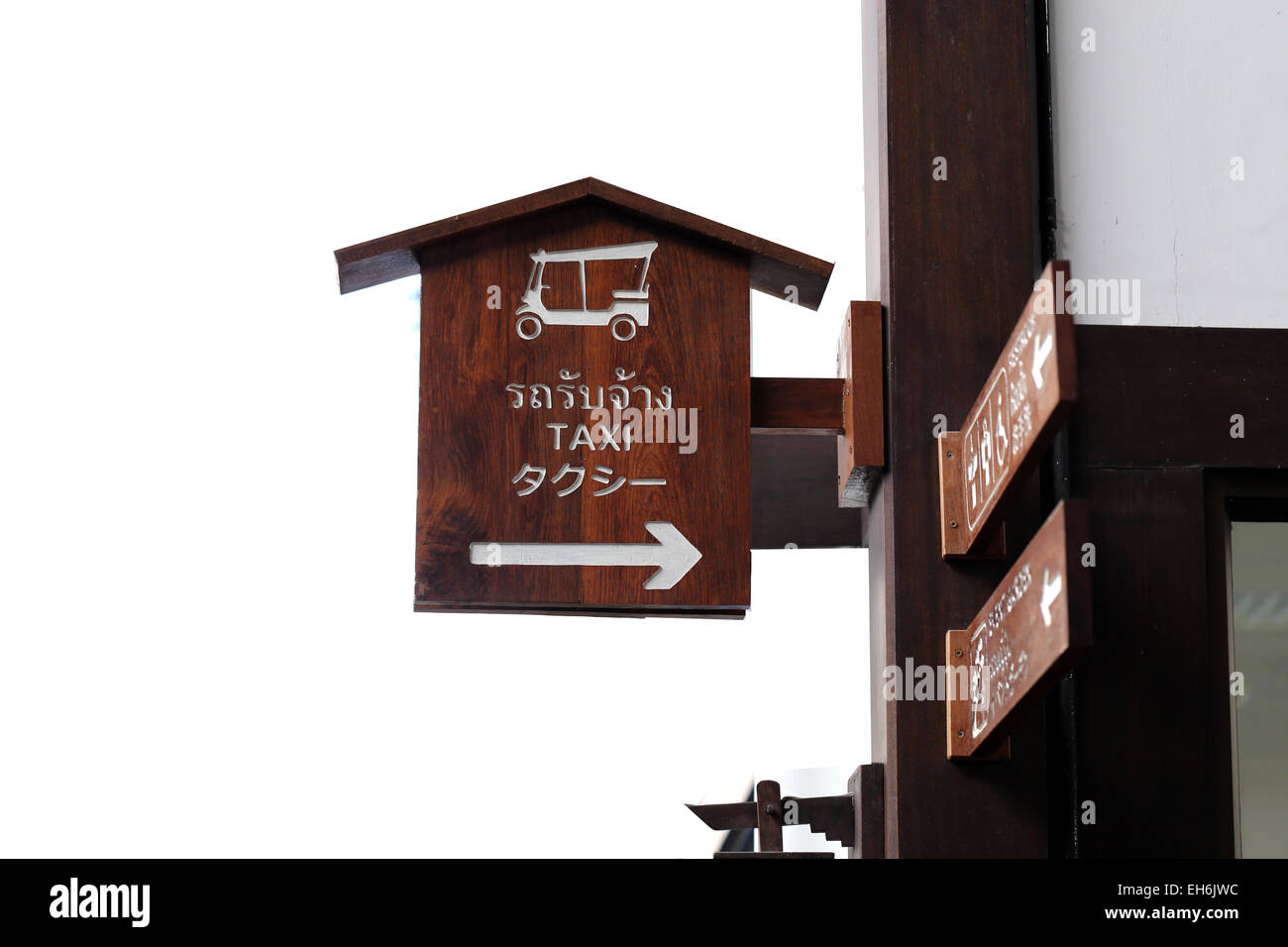 Wood signs to the taxi in Bus Station Stock Photo - Alamy