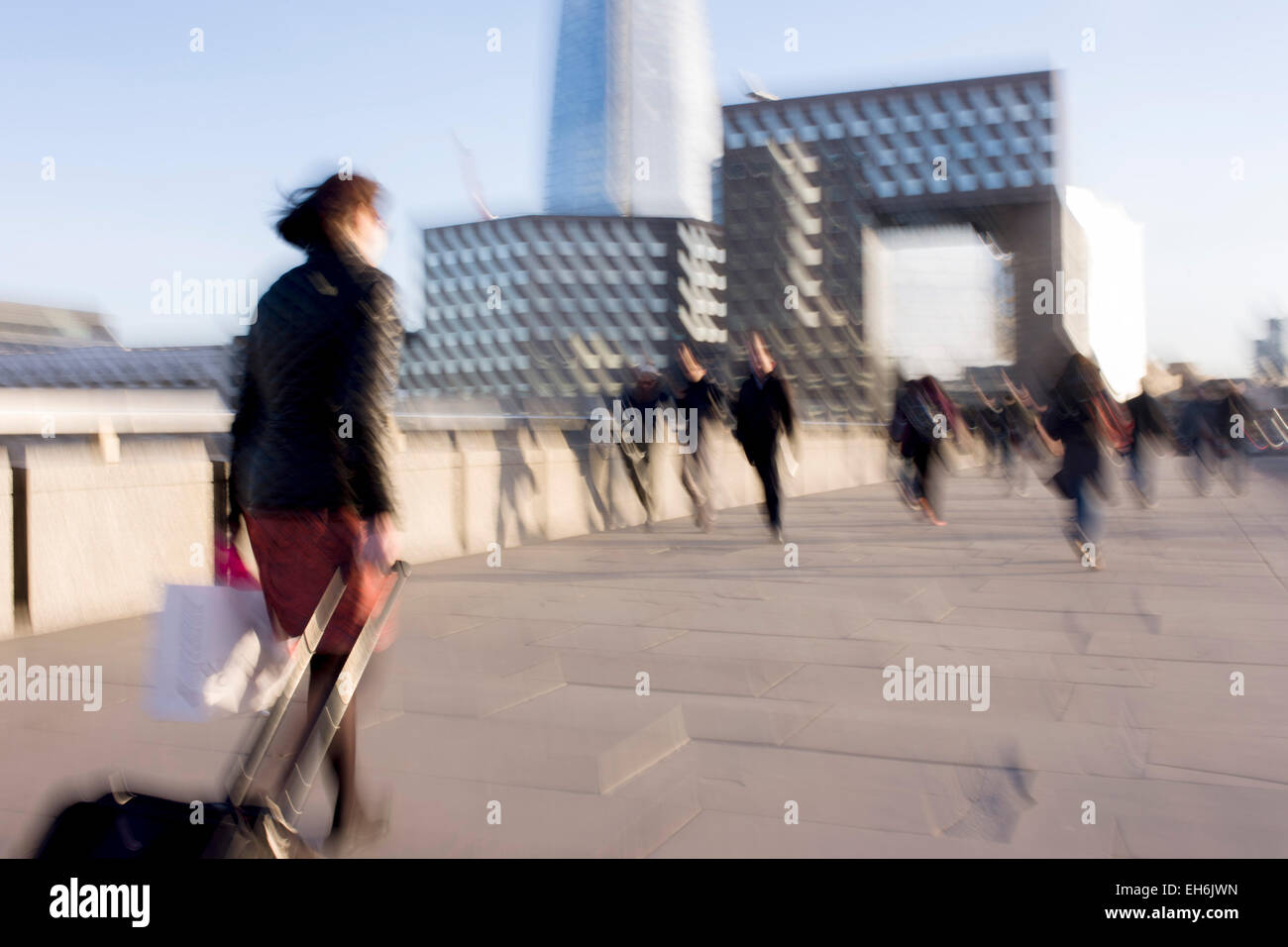 Blurred commuters walk over London Bridge, south from the City of ...