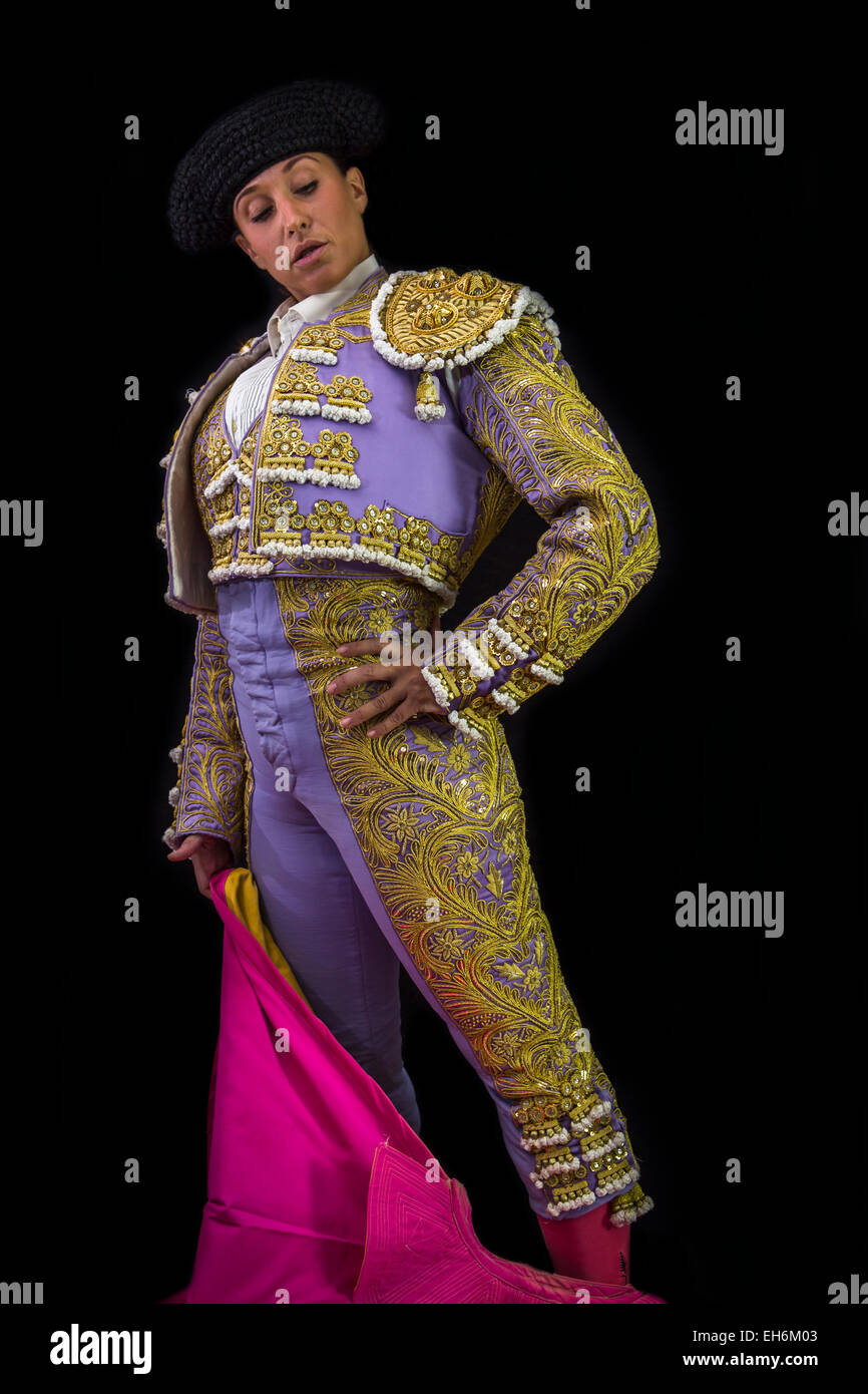 Woman bullfighter holding capote pink on black background Stock Photo ...