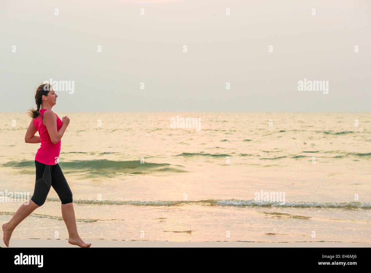 woman running barefoot on the sandy beach Stock Photo - Alamy