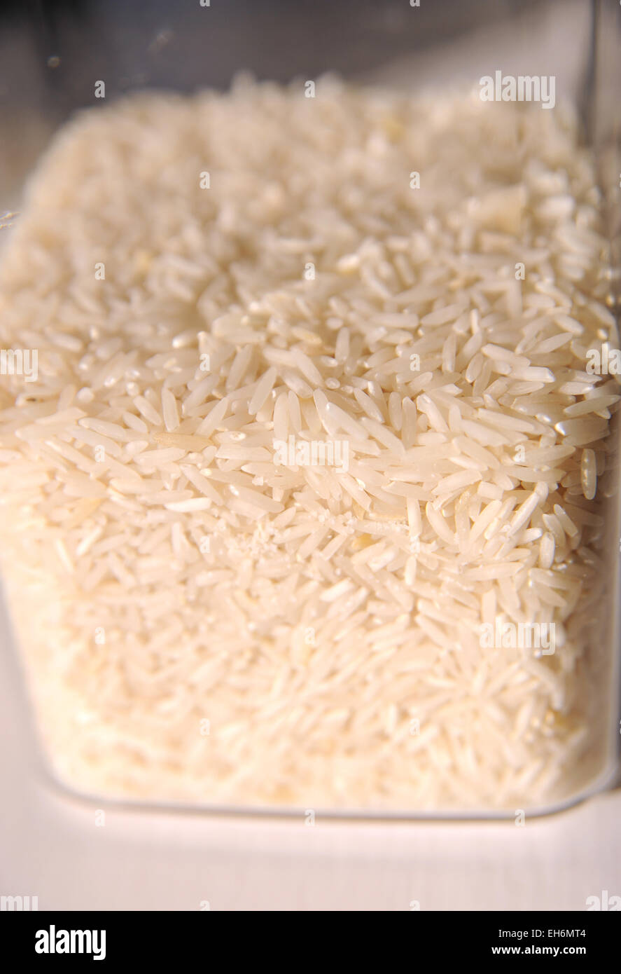 Basmati white rice in container for Indian or Thai cooking Stock Photo ...