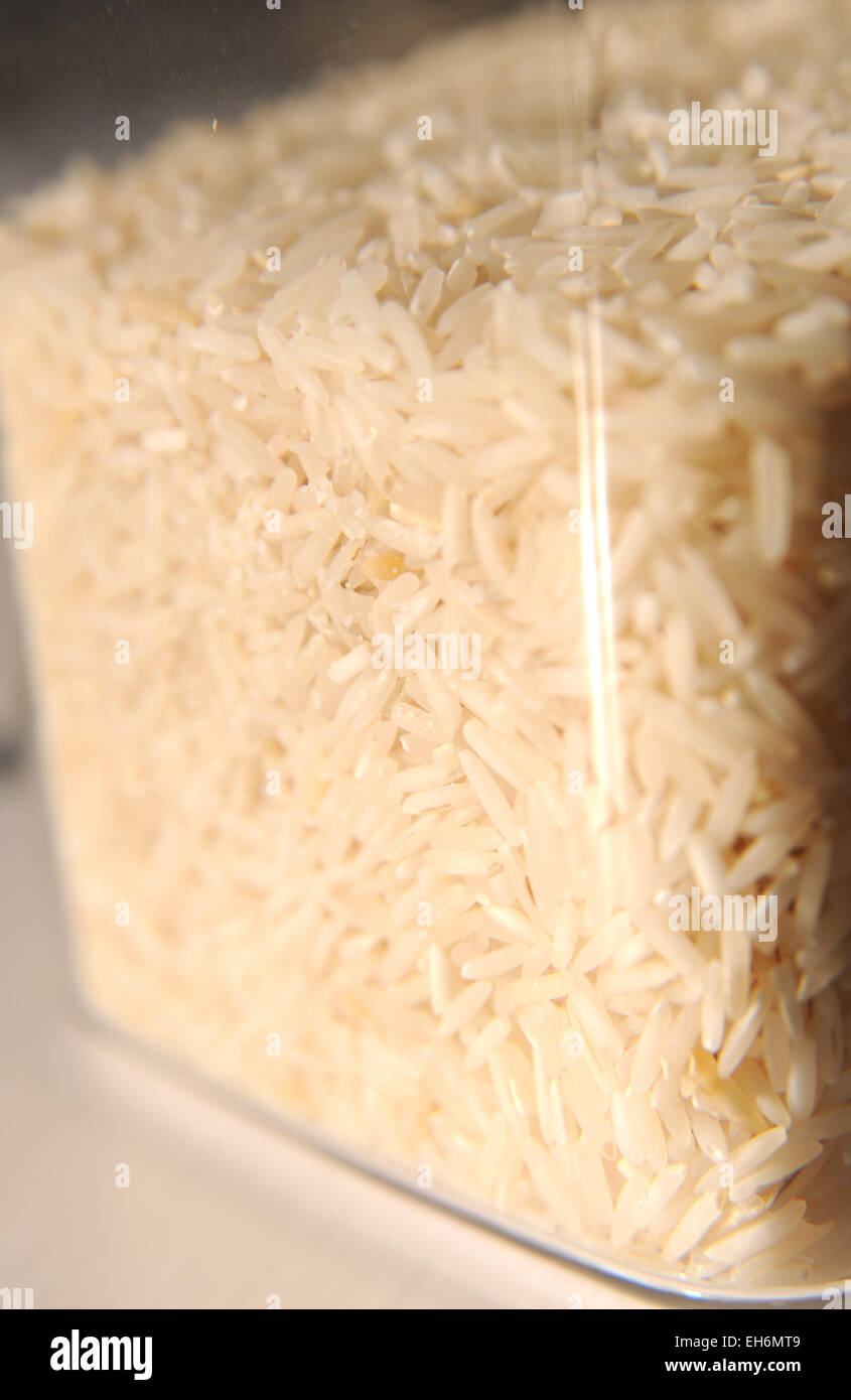 Basmati white rice in container for Indian or Thai cooking Stock Photo ...