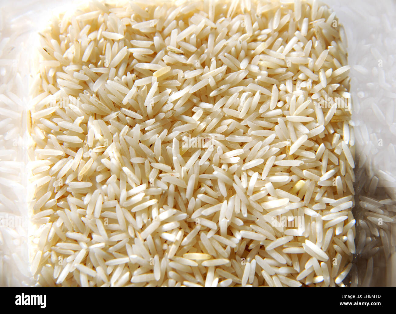 Basmati white rice in container for Indian or Thai cooking Stock Photo ...