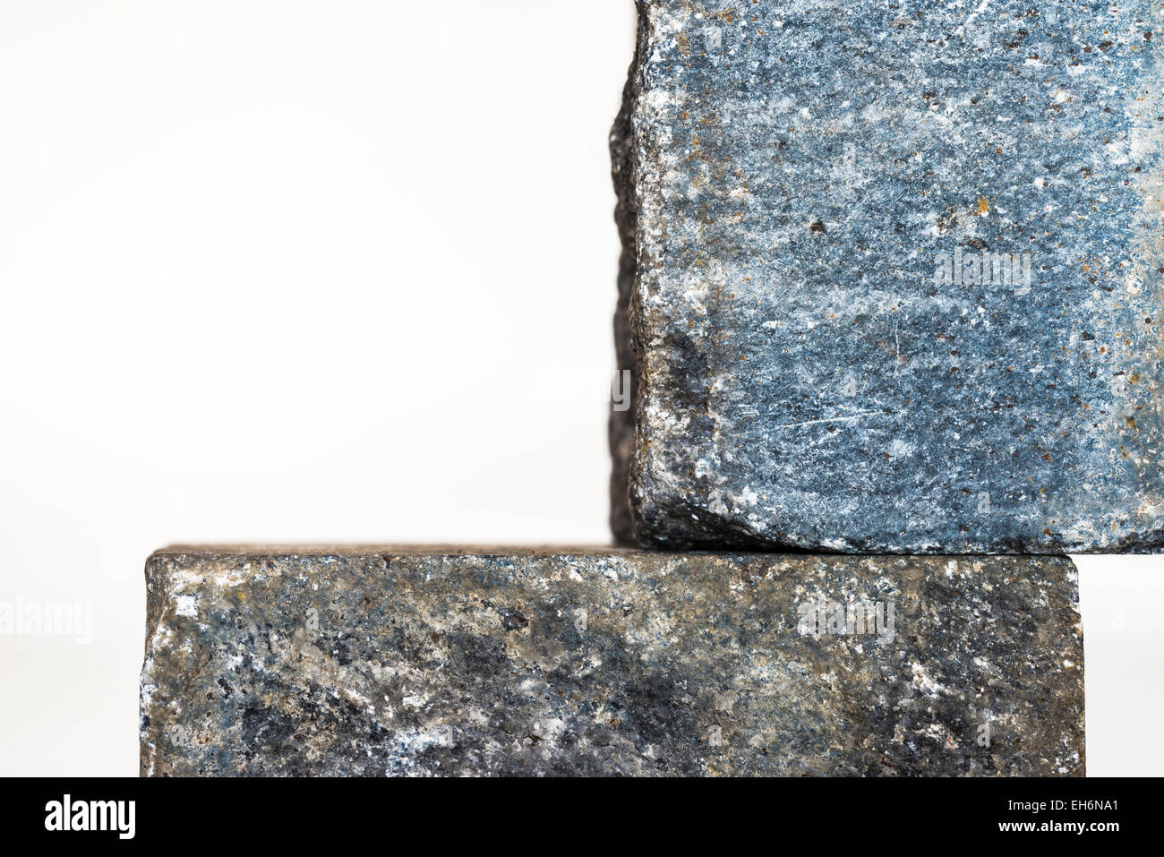 Macro of the surface two cube-shaped stones isolated on white ...
