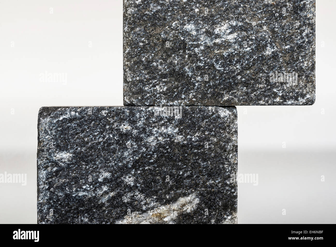 Macro of the surface two cube-shaped stones isolated on white ...