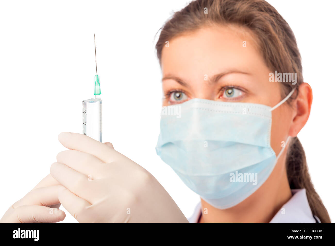 doctor concentrated in sterile clothing with syringe isolated Stock ...