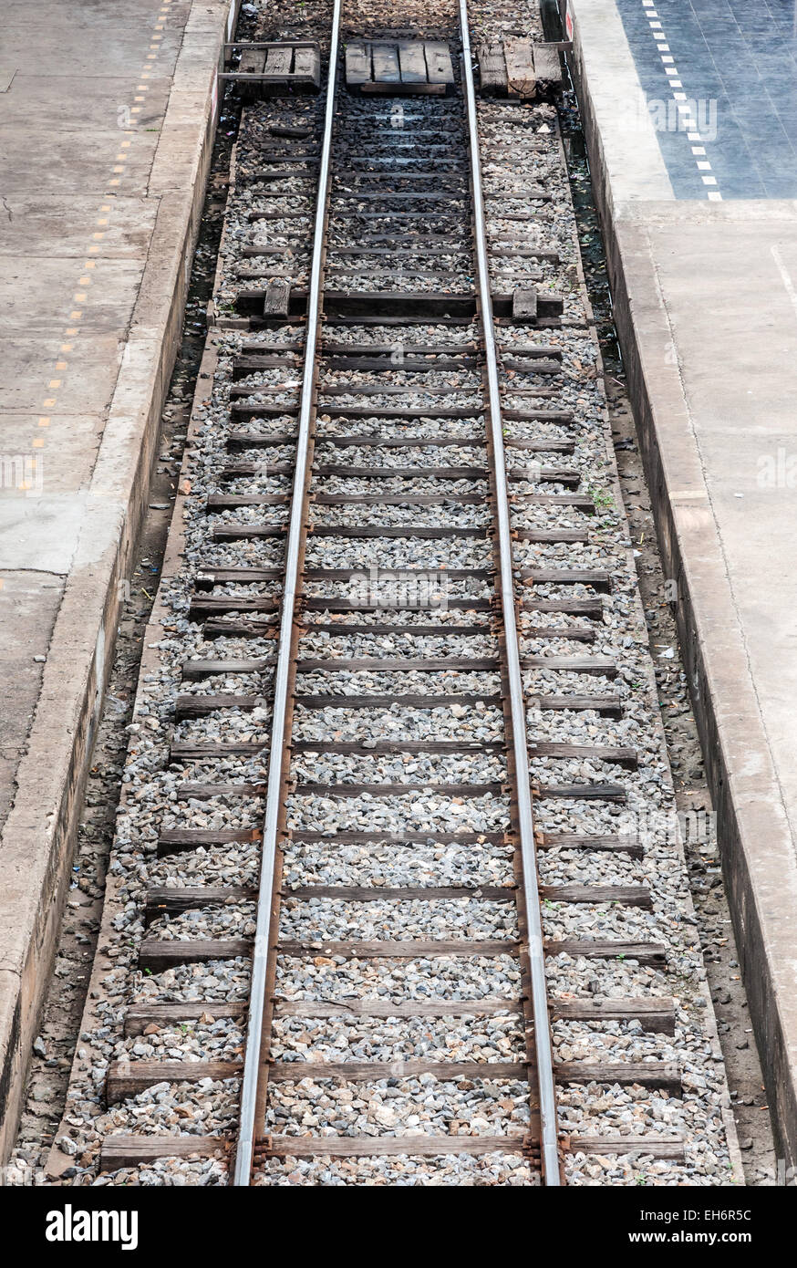 Straight railway line in the urban station Stock Photo - Alamy