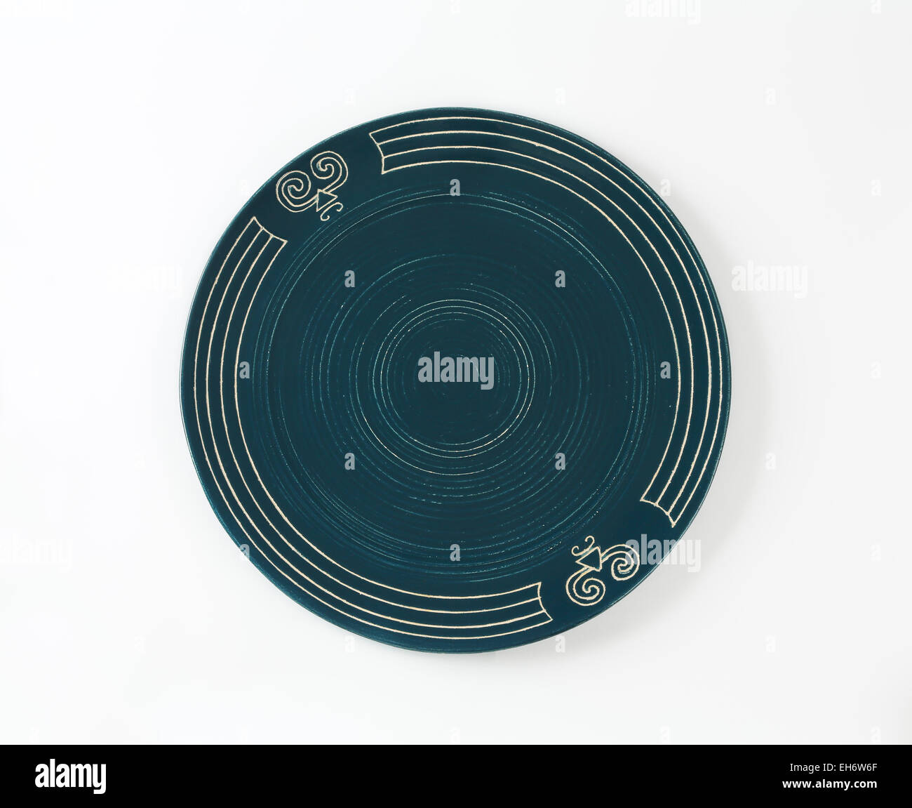 Handcrafted ceramic plate with engraved symbols Stock Photo - Alamy