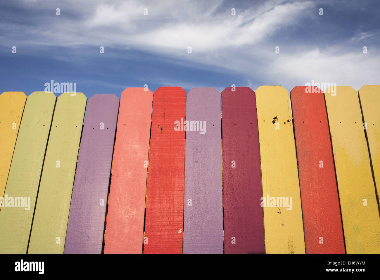 Wooden Rainbow Fence with blue sky Stock Photo - Alamy