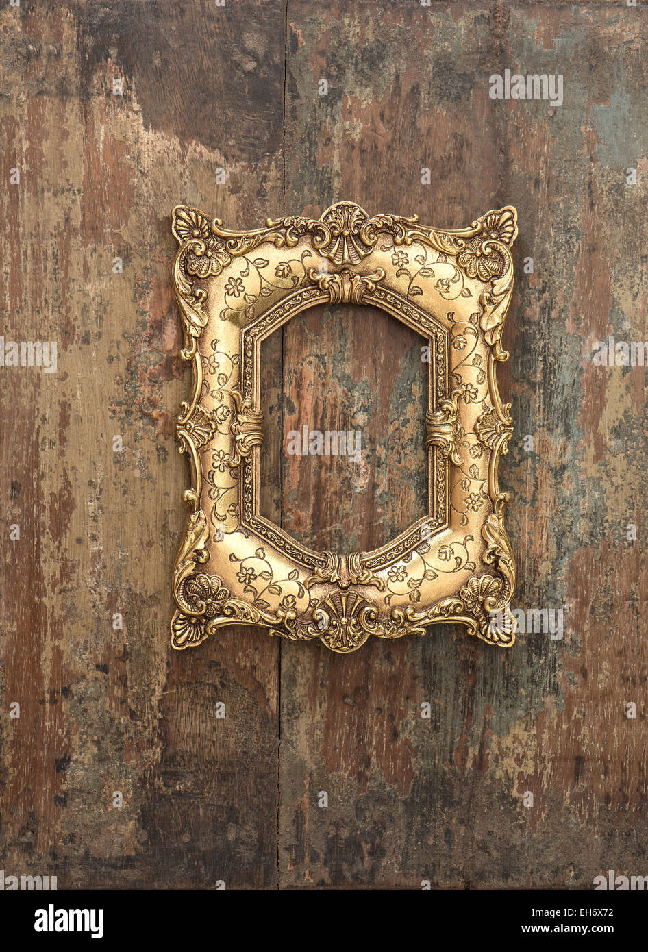 Baroque golden frame over rustic wooden background. Grunge wood texture ...
