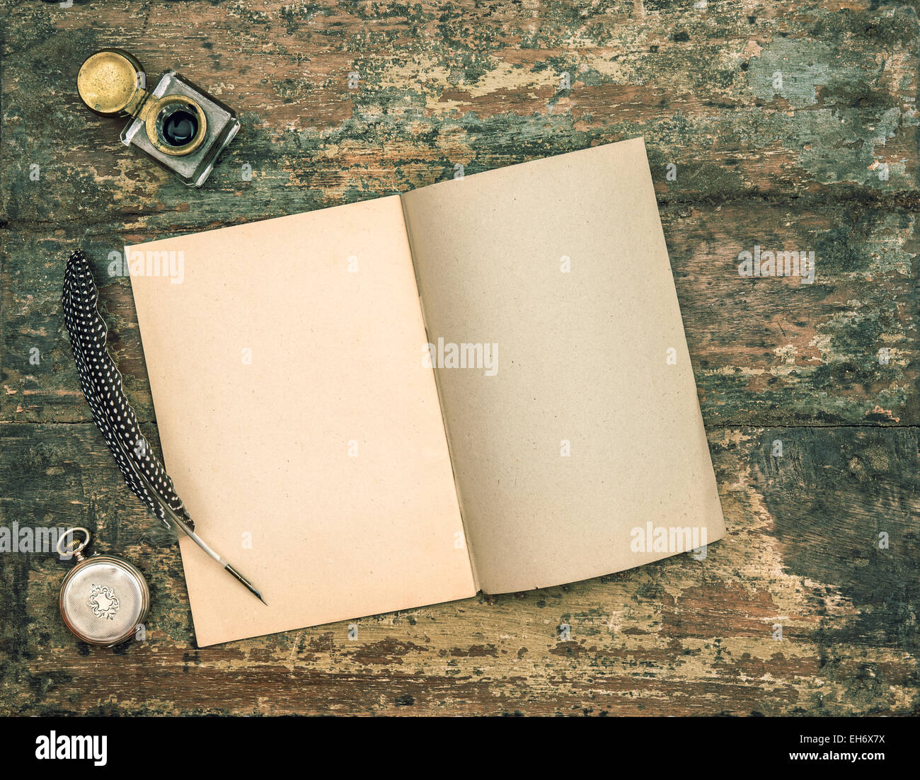Open book and vintage writing accessories. Feather pen and inkwell on ...