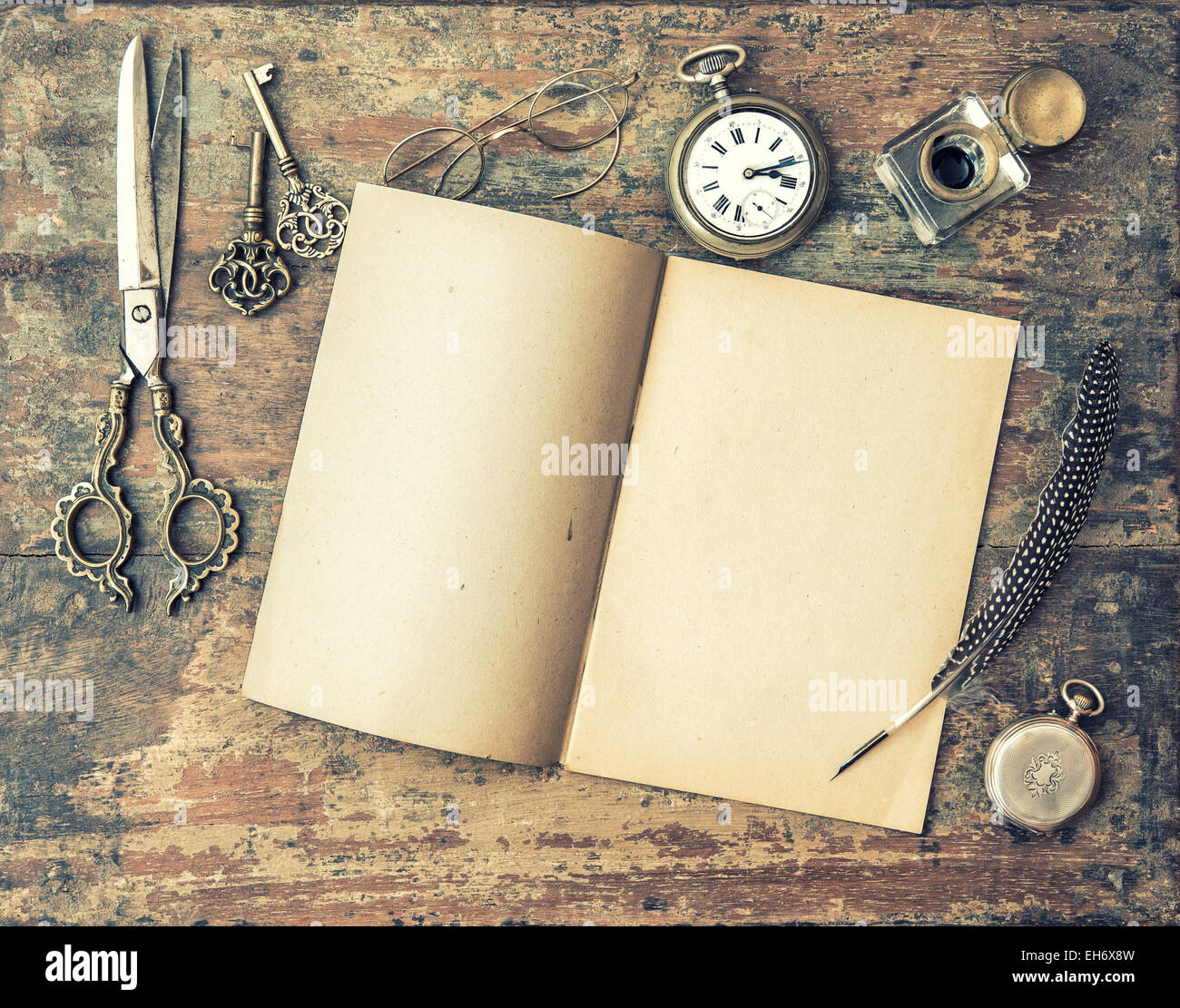 Open journal book and vintage writing tools on wooden table. Feather ...