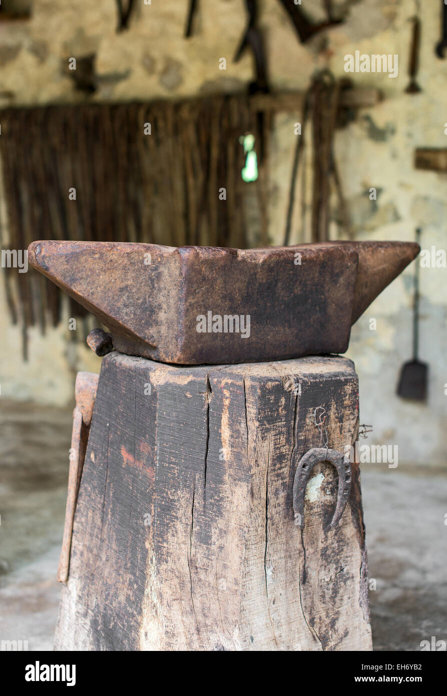 Old anvil on the wooden stump Stock Photo - Alamy