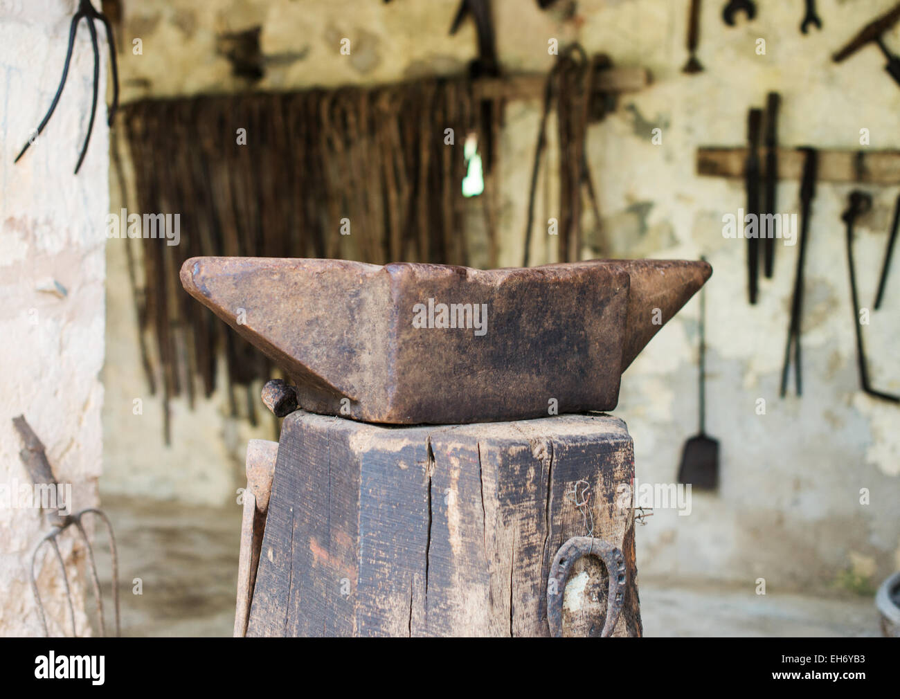 Old anvil on the wooden stump Stock Photo - Alamy
