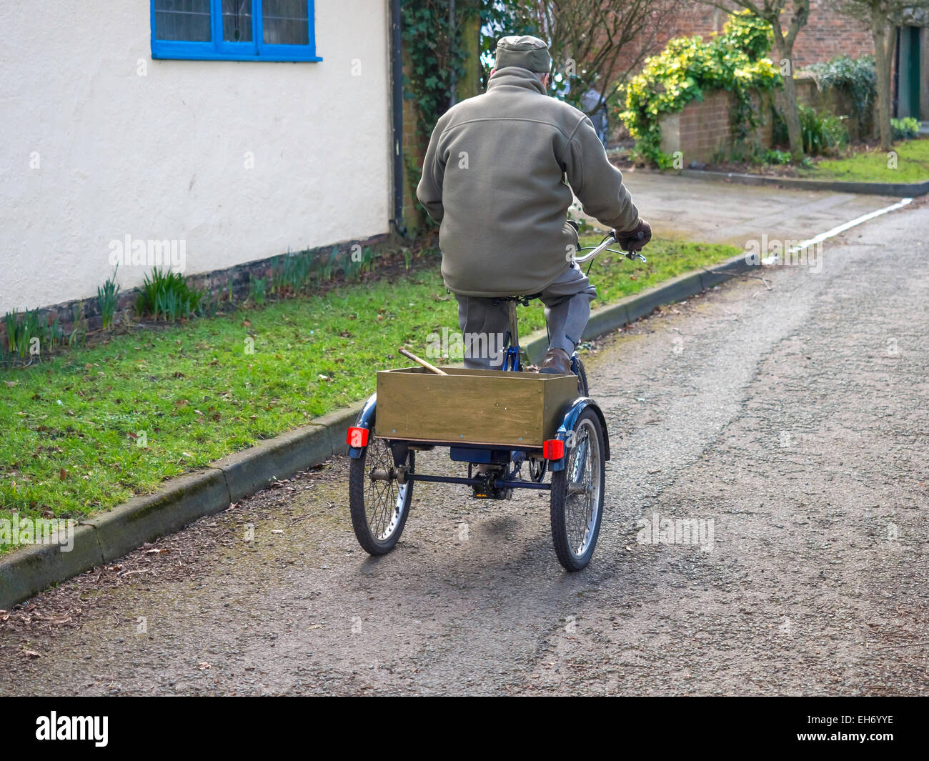 Elderly man riding on a tricycle on a quiet lane Stock Photo - Alamy