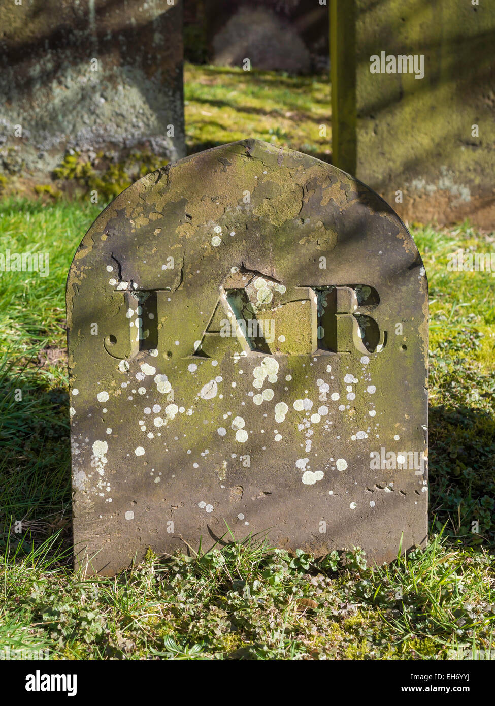 An old gravestone with the inscription only the initials J.A.R Stock ...