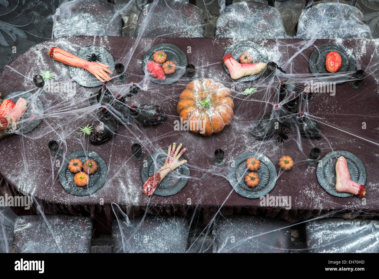 Dinner with human body parts on the table emblazoned with cobwebs Stock ...