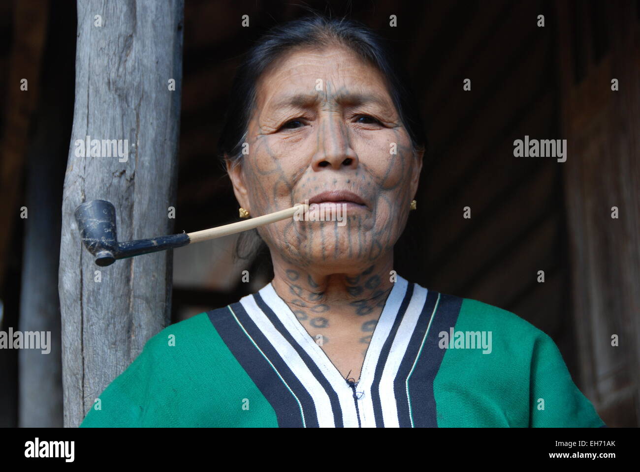 Chin Tribal Woman with Tattooed Face smoking pipe, Kanpetlet Chin ...