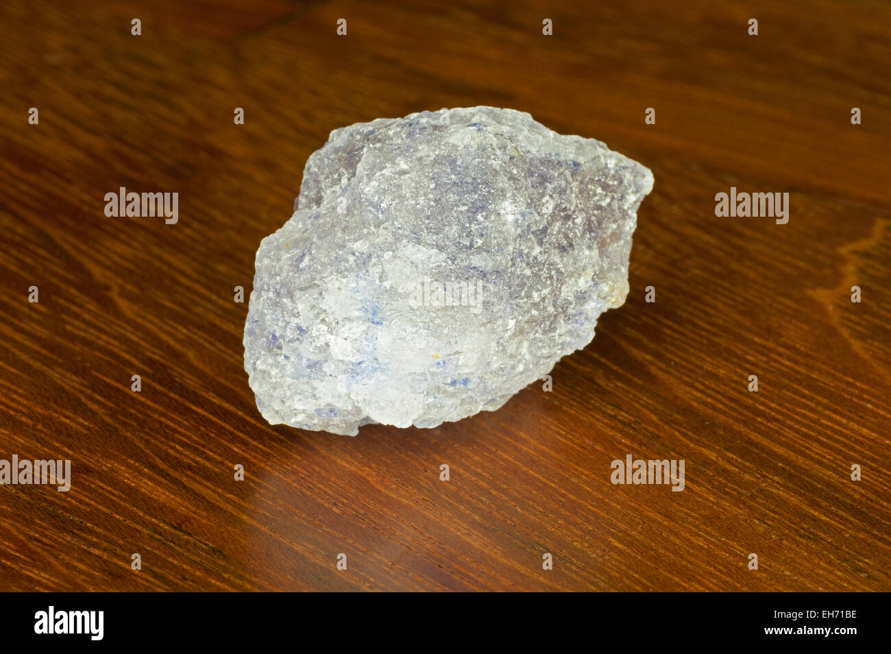 persian blue rock salt piece sitting on wood Stock Photo - Alamy