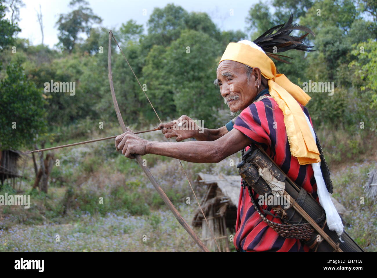 Tribal man wearing traditional costume with bow and arrows, Kanpetlet ...