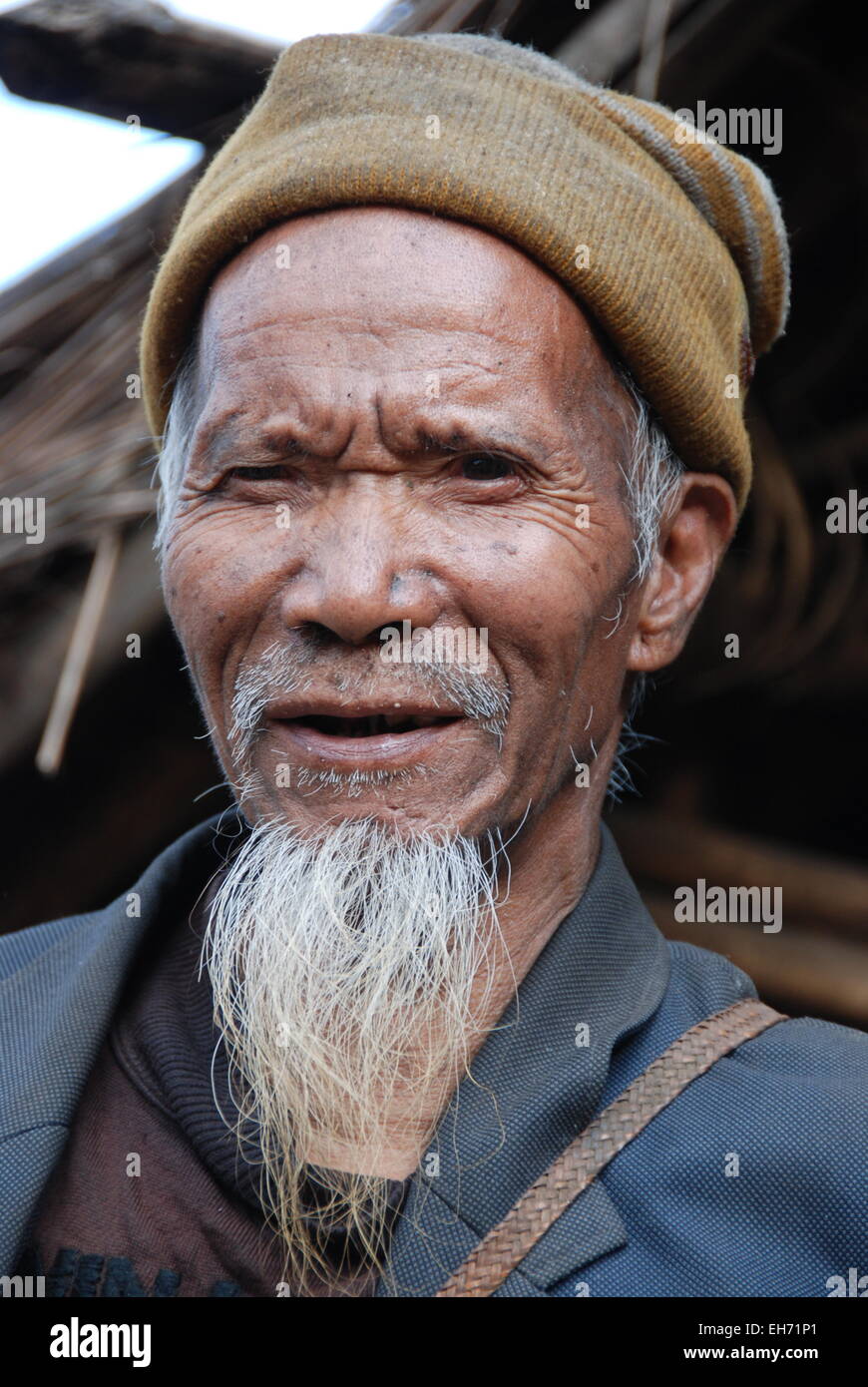 Tribal man wearing traditional costume in front of his house, Kanpetlet ...