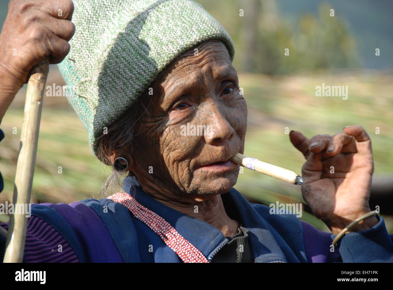 Chin Tribal Woman with tattooed face smoking cheroot cigar, Kanpetlet ...