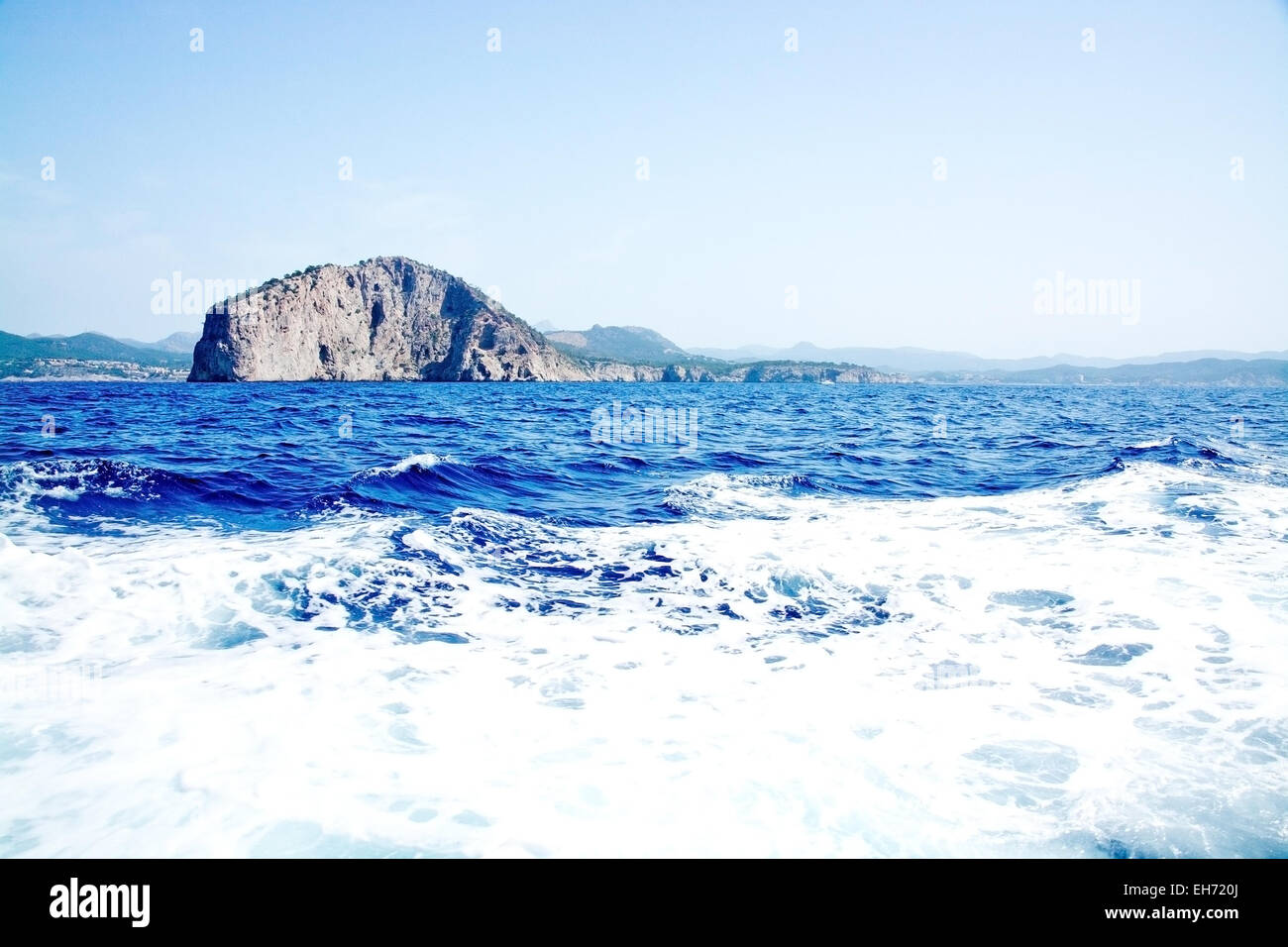Abstract boat wake in clear blue water fading into white copy space ...