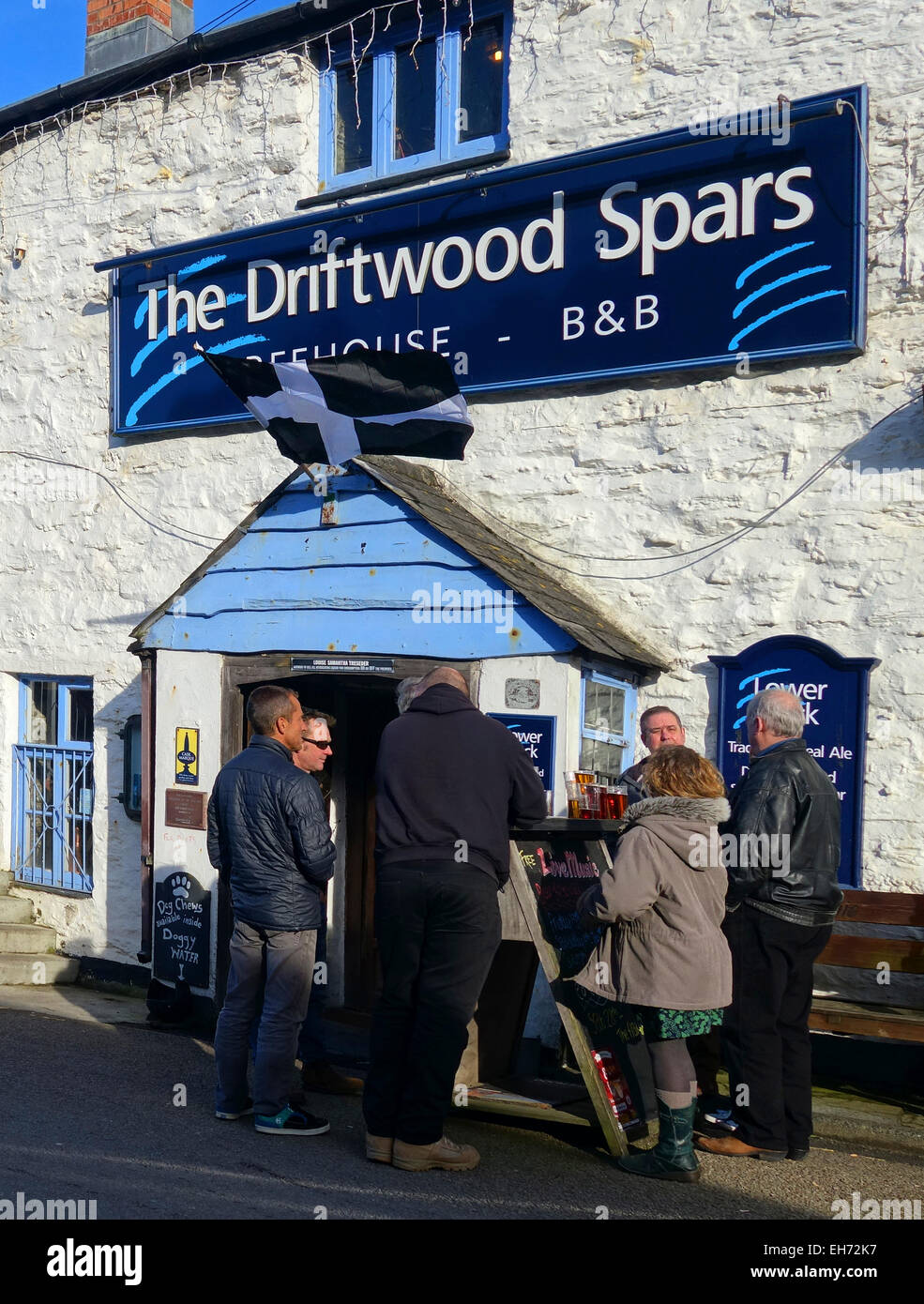 Customers having a lunchtime drink outside the Driftwood Spars pub in ...