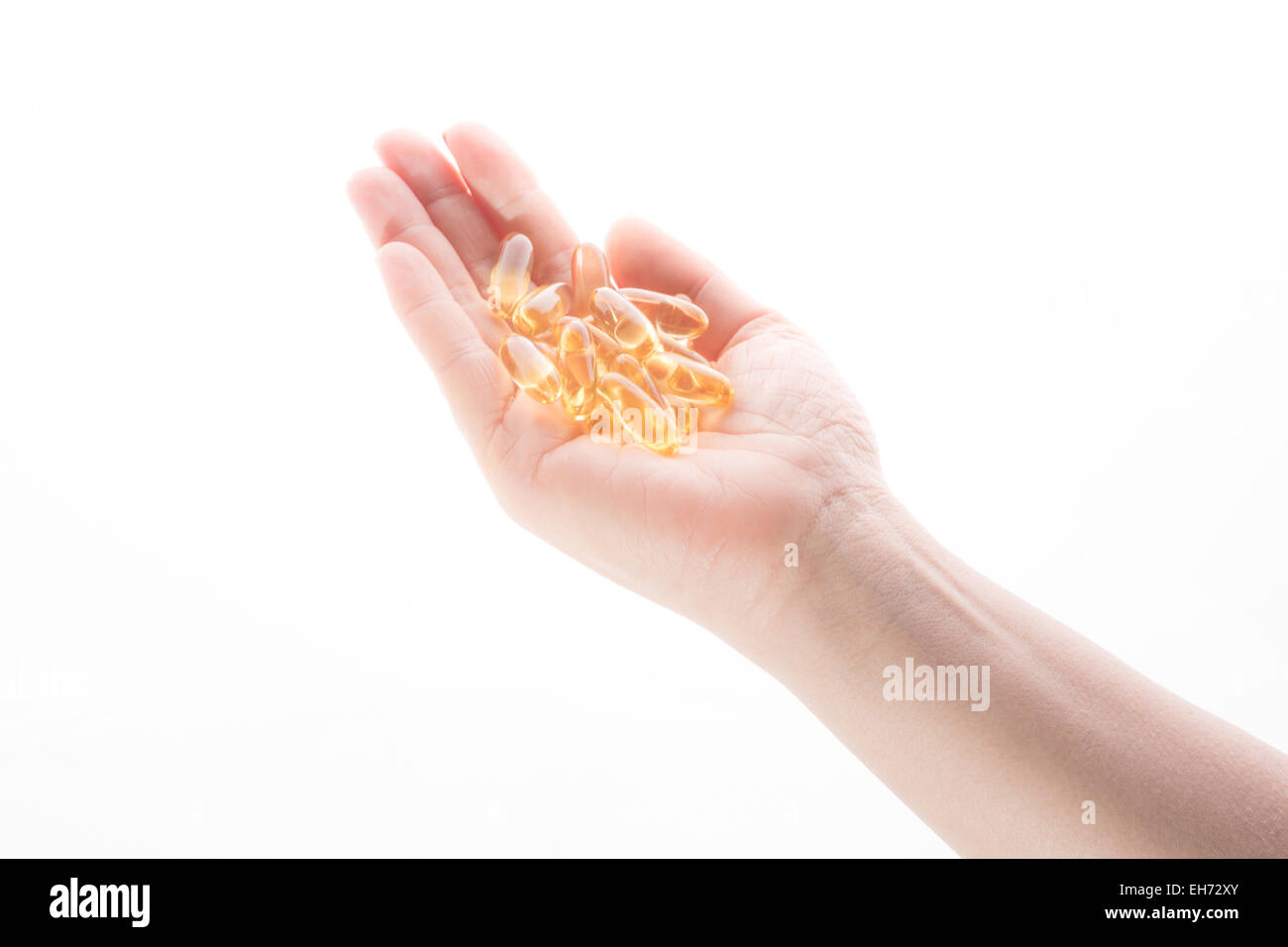 Female hand with pill capsules on white background Stock Photo - Alamy