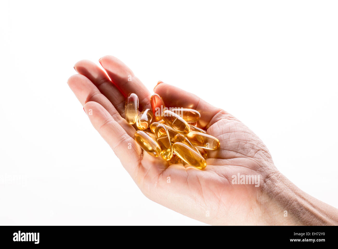 Female hand with pill capsules on white background Stock Photo - Alamy