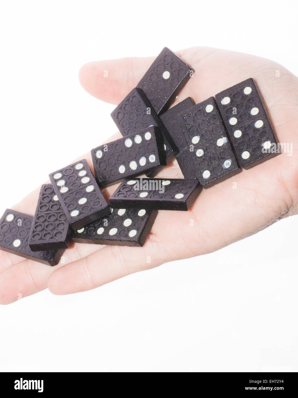 Dominoes in female hand on a white background Stock Photo - Alamy