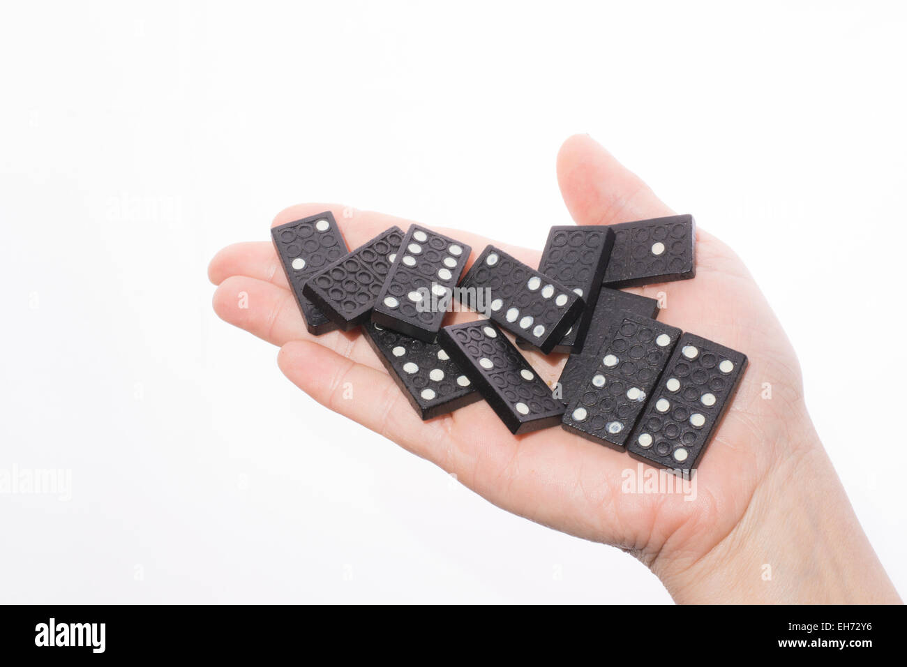 Dominoes in female hand on a white background Stock Photo - Alamy
