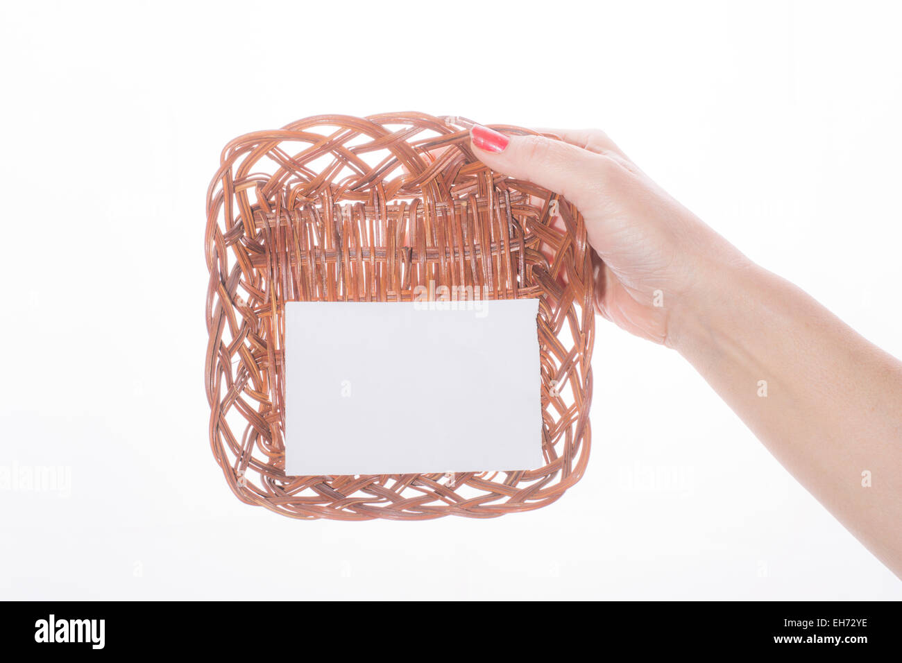 Female hand holding a small basket with blank note Stock Photo - Alamy