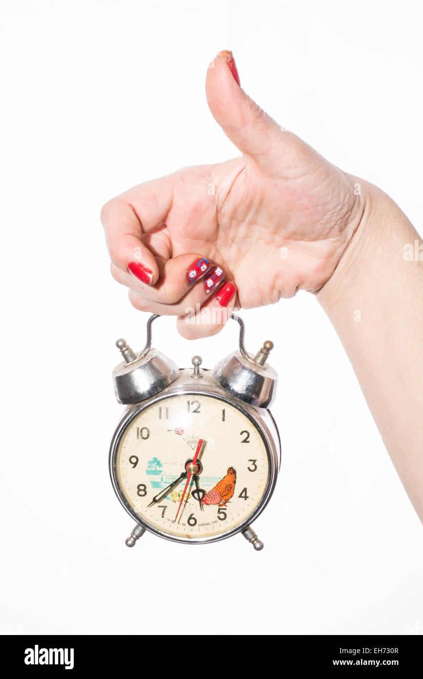 fingers holding retro watch over white background Stock Photo - Alamy