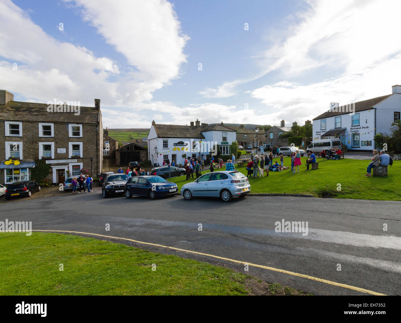 People gathering on the green in Reeth, Yorkshire dales National Park ...